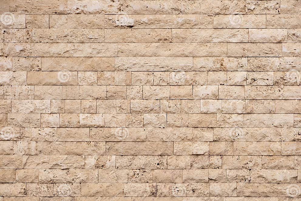 Textured Beige Stone Wall with Rectangular Blocks in a Modern ...