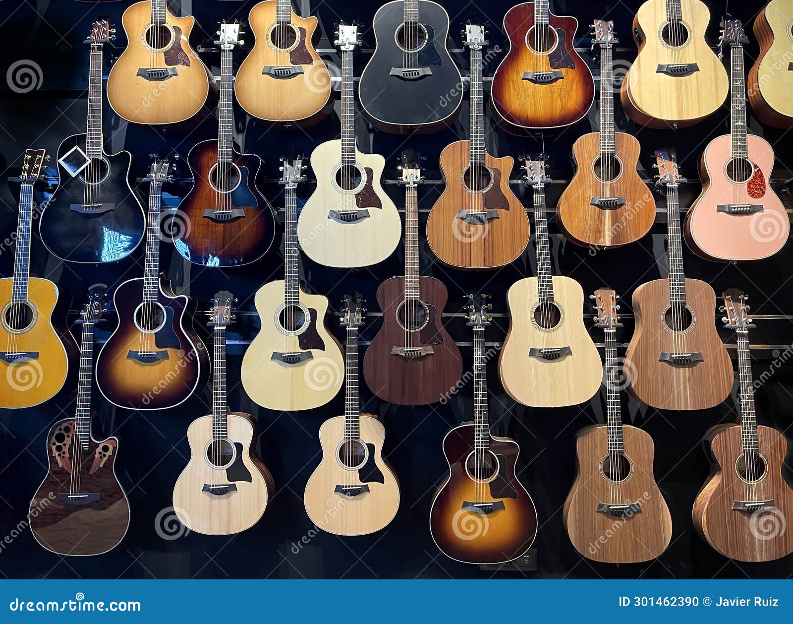A Wall Full of Acoustic Guitars of Different Models and Types of Wood ...