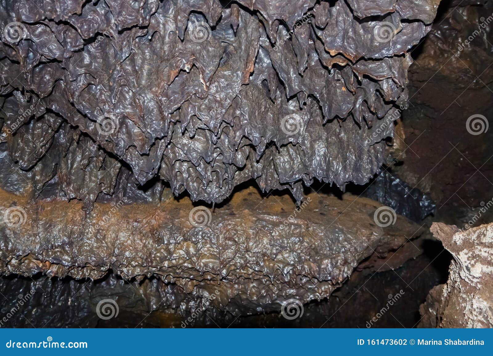 The Smooth Wall of the Lava Cave is Covered with Stalactites. the View ...