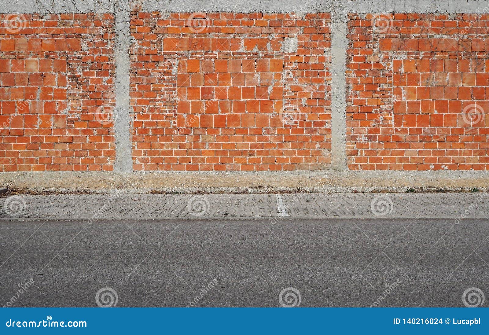 Brick Wall with Sidewalk and Asphalt Road in Front. Urban Background ...