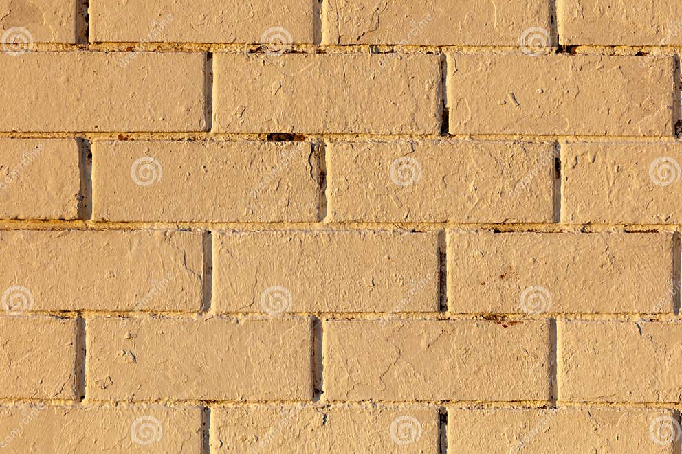 A wall made of tan bricks stock photo. Image of concrete - 345850840