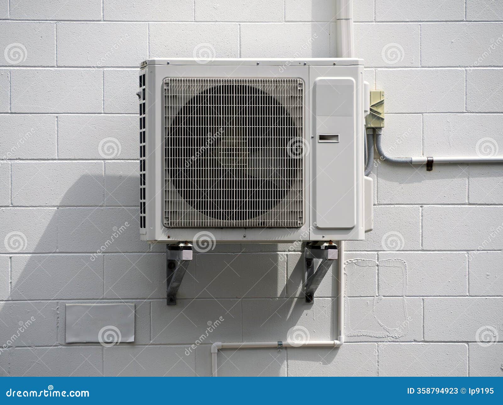 Wall-Mounted Air Conditioning Unit At White Brick Wall Royalty-Free ...