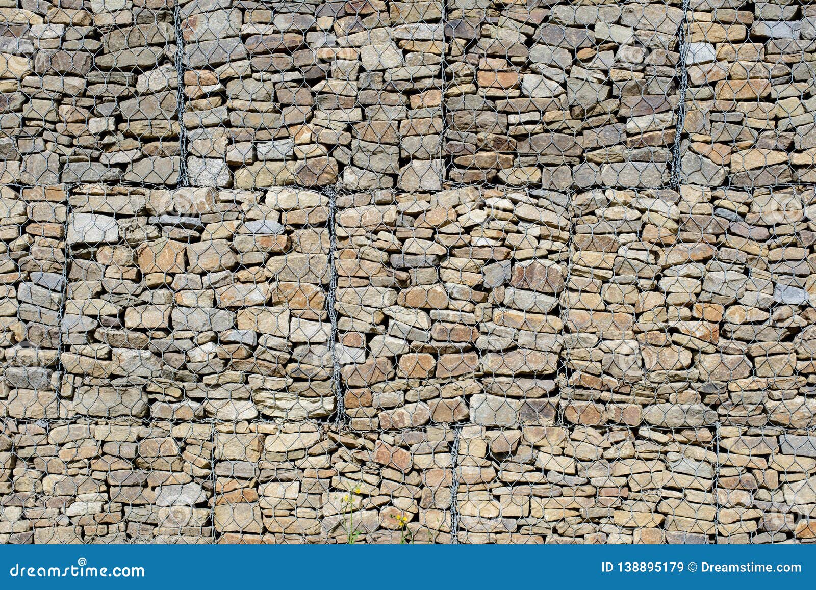 The Wall of Multi-colored Stones Covered with Iron Mesh Stock Image ...