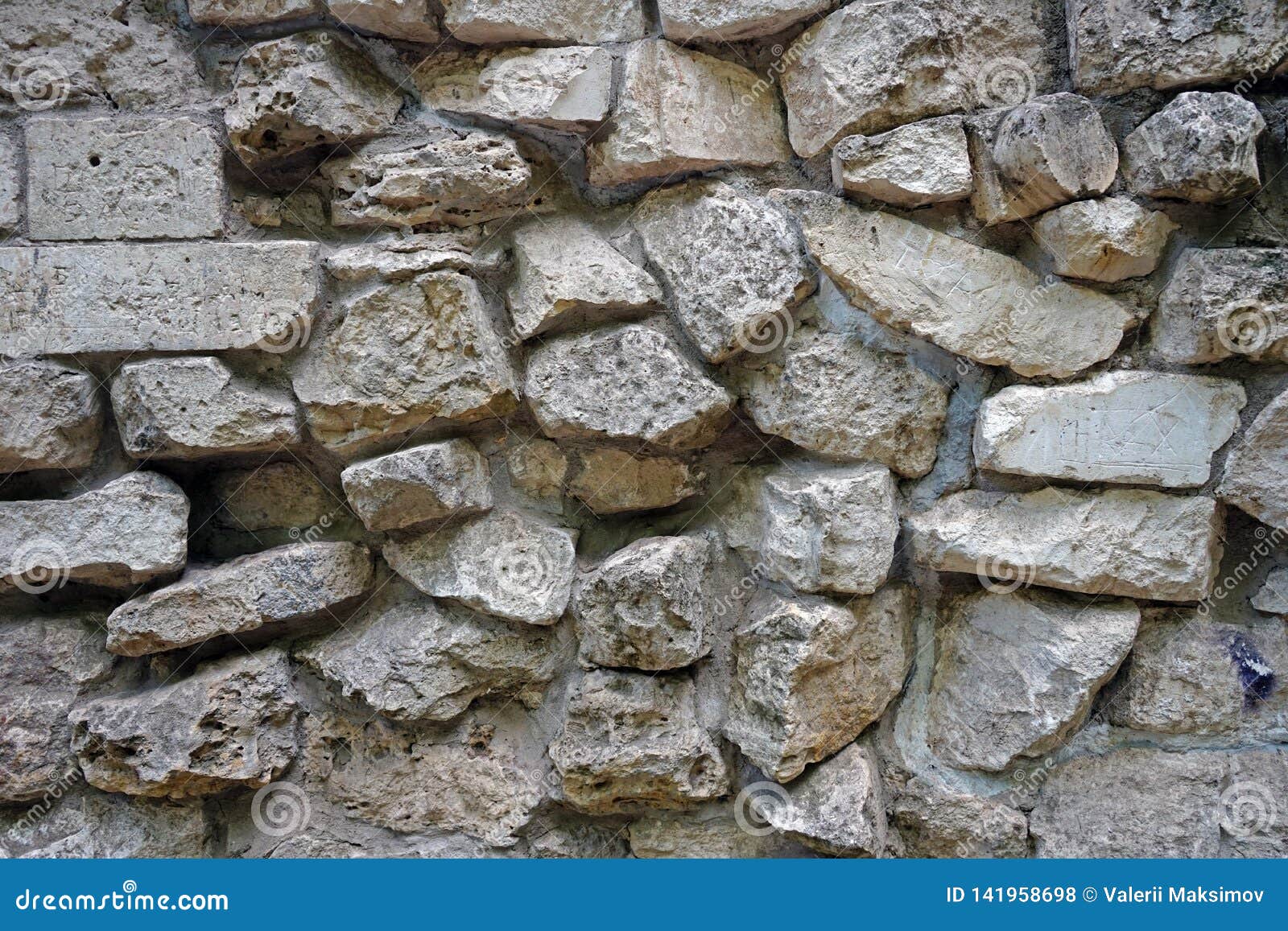 The Wall of Natural Stones of Different Sizes Stock Photo - Image of ...