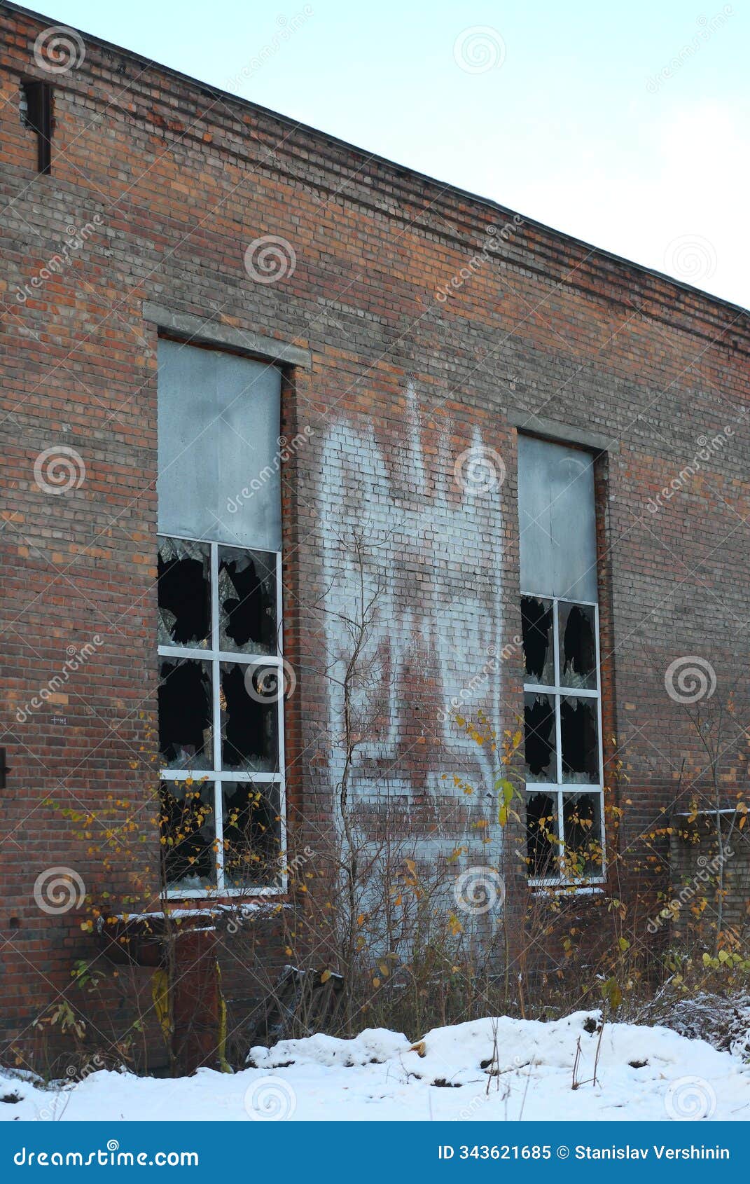 The Wall of an Old Brick Building with Broken Windows and Graffiti ...