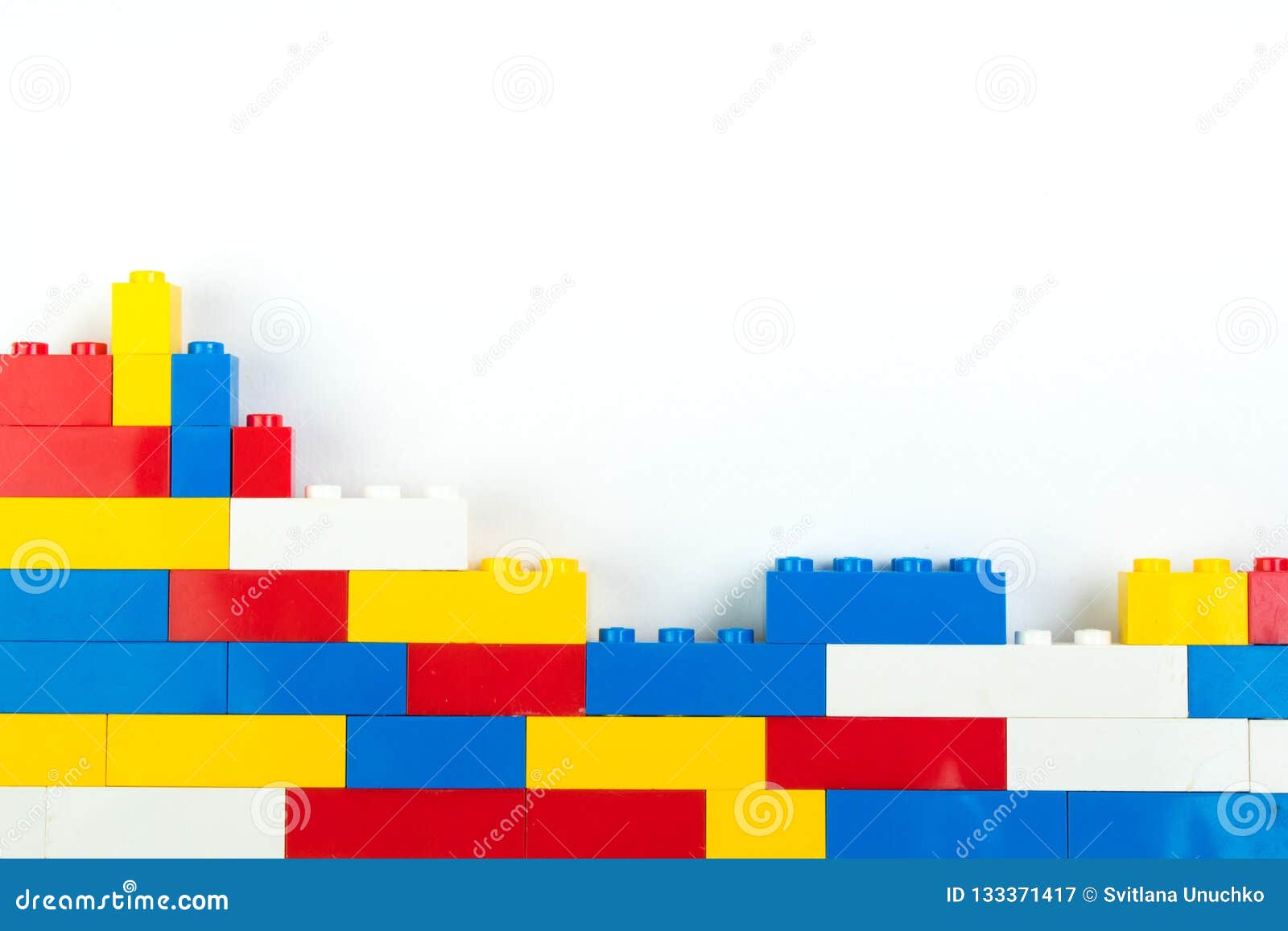 Wall from Plastic Building Blocks Isolated on White Background. Top ...
