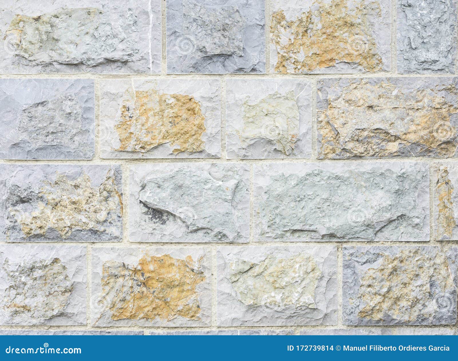 A Wall of Rectangular Limestone Stones in Different Shades of Ochre ...