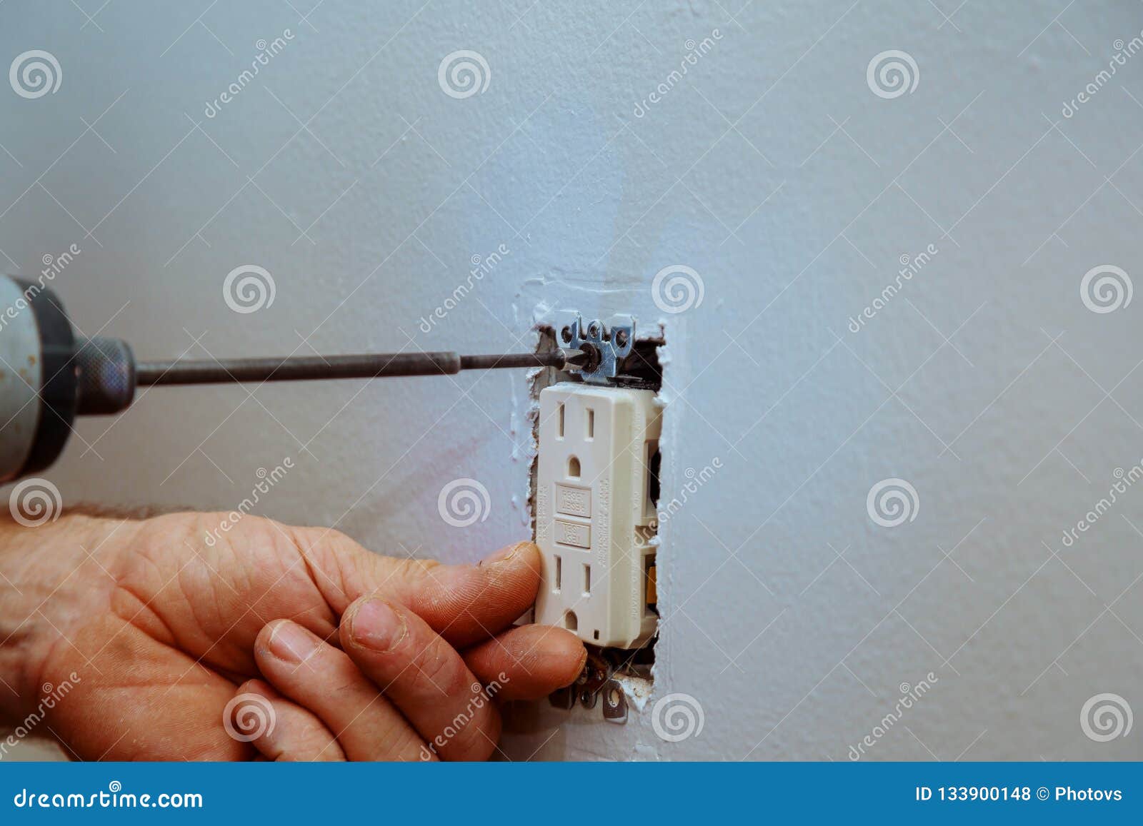 Tightening a on an Electrical Outlet Stock Photo - Image of repair ...