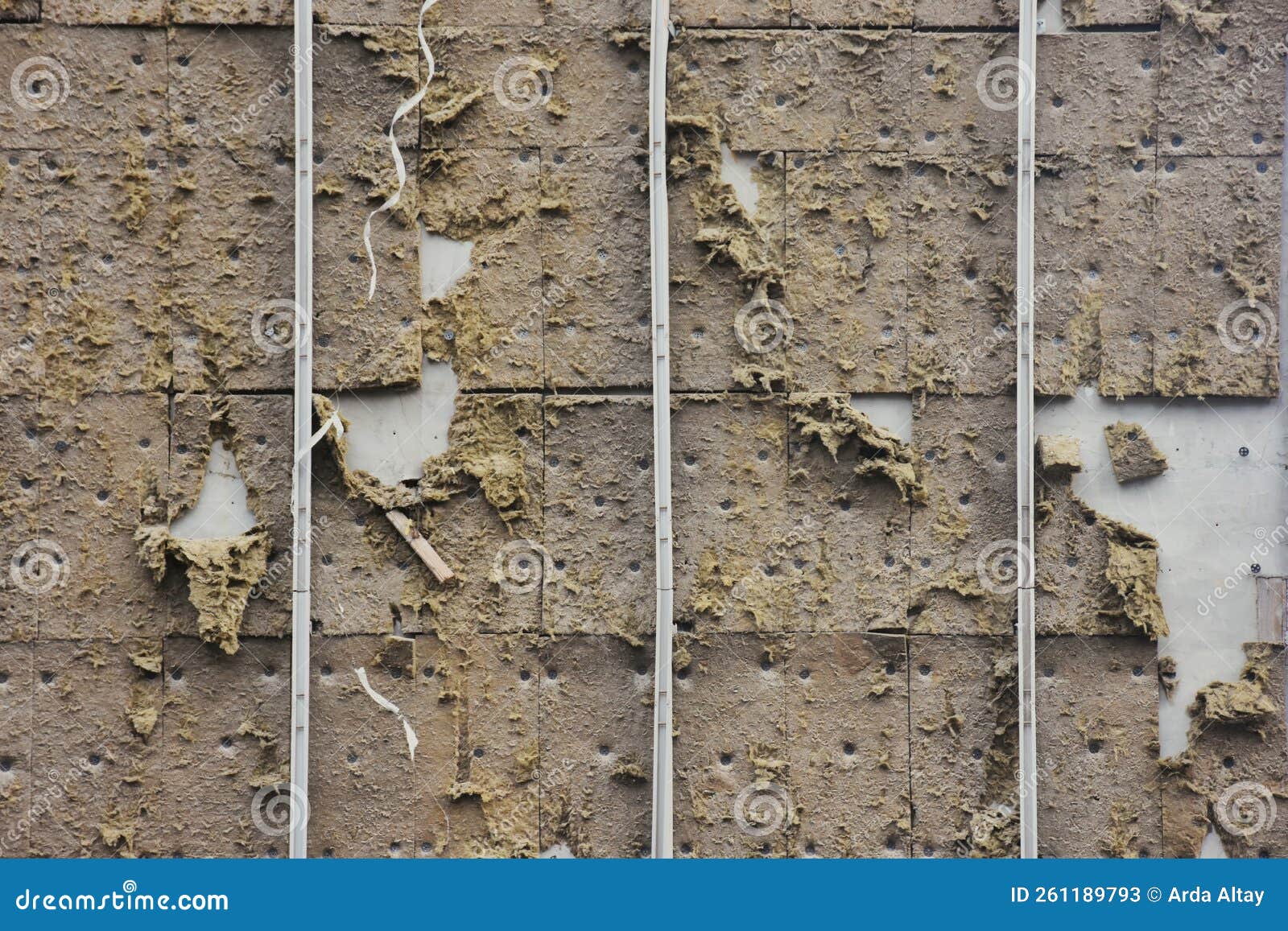Wall Surface of a Being Demolished Building and Worn Insulation Material and Plastic Pipes on it ...