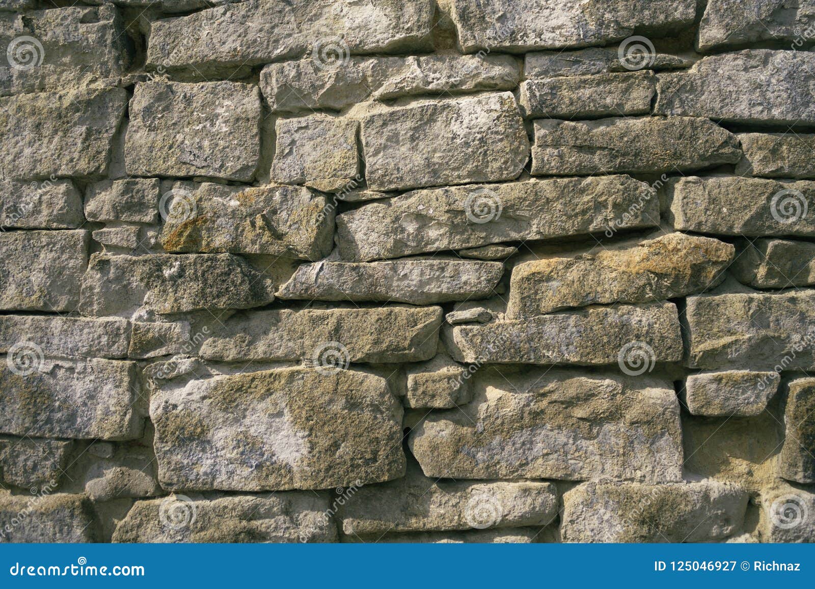 A wall of uneven stones stock image. Image of house - 125046927