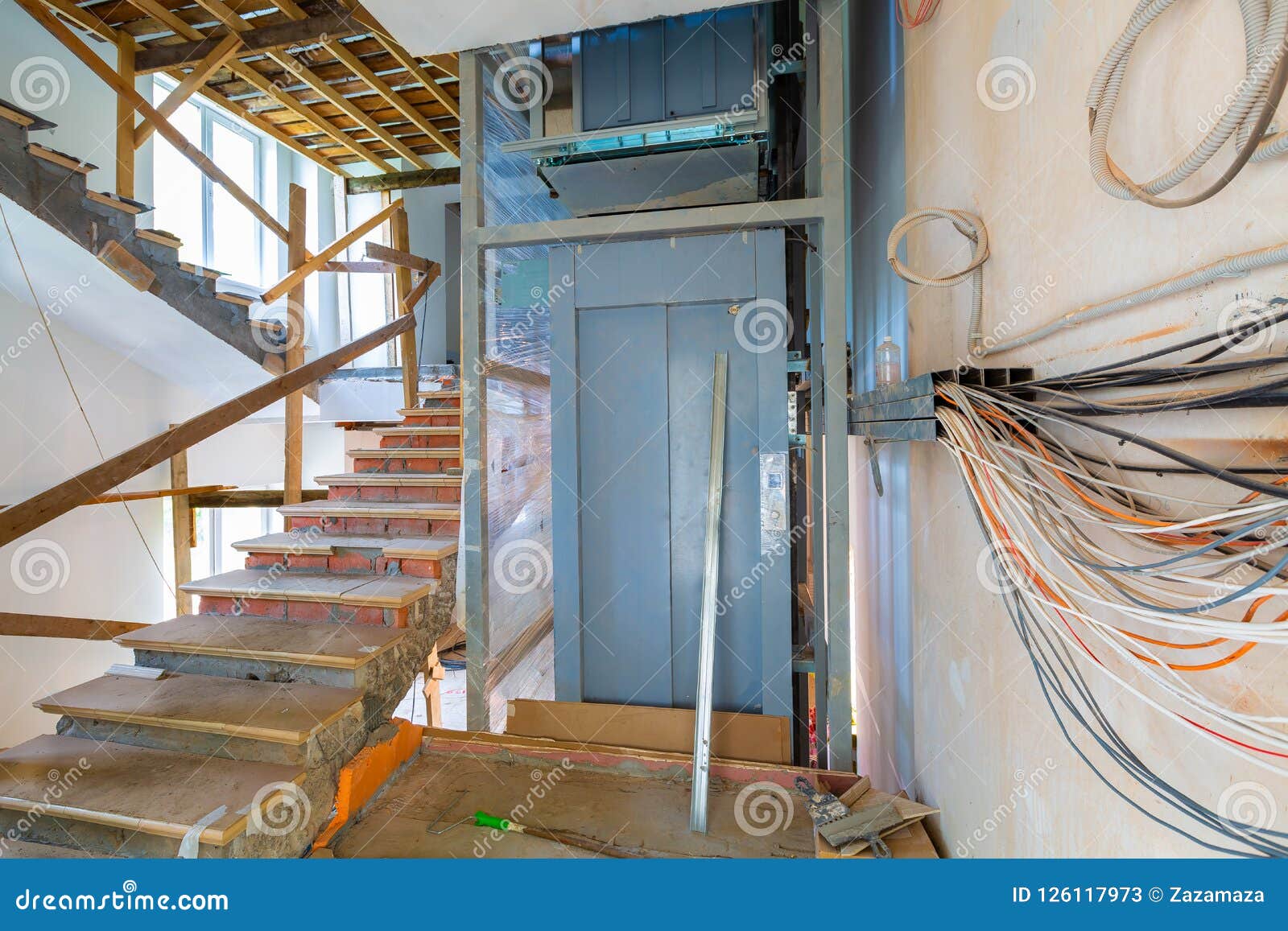 Wall with Wires, Stairs with Temporary Wooden Railing and Elevator in ...