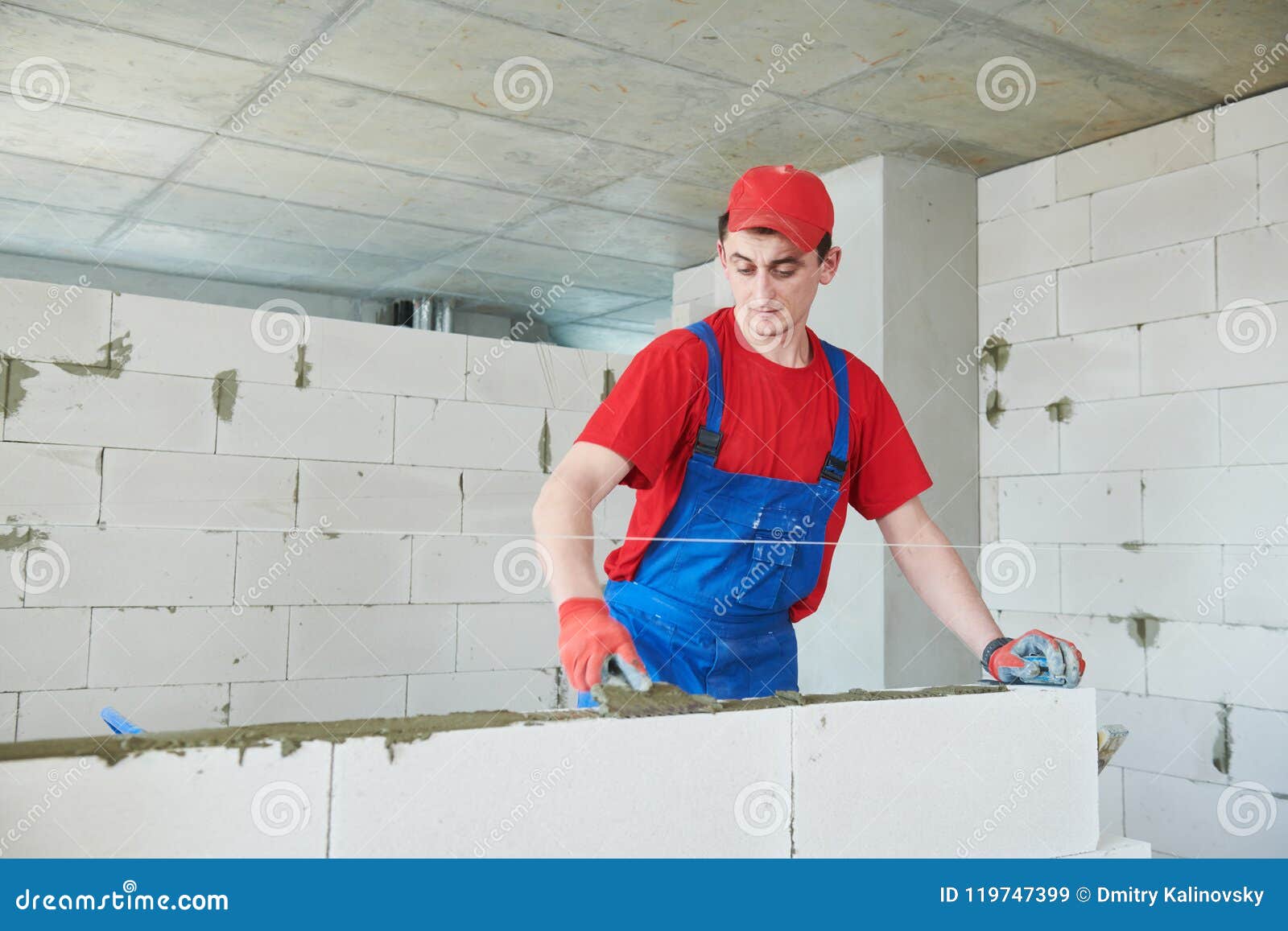 Walling. Bricklayer Installing Autoclaved Aerated Concrete Blocks ...
