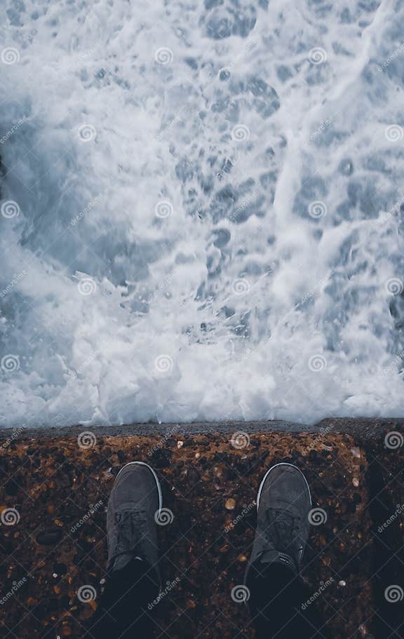 Wallpaper of a Person Standing on a Rock with Wave Hitting the Rock ... Wallpaper of a Person Standing on a Rock with Wave Hitting the Rock ...