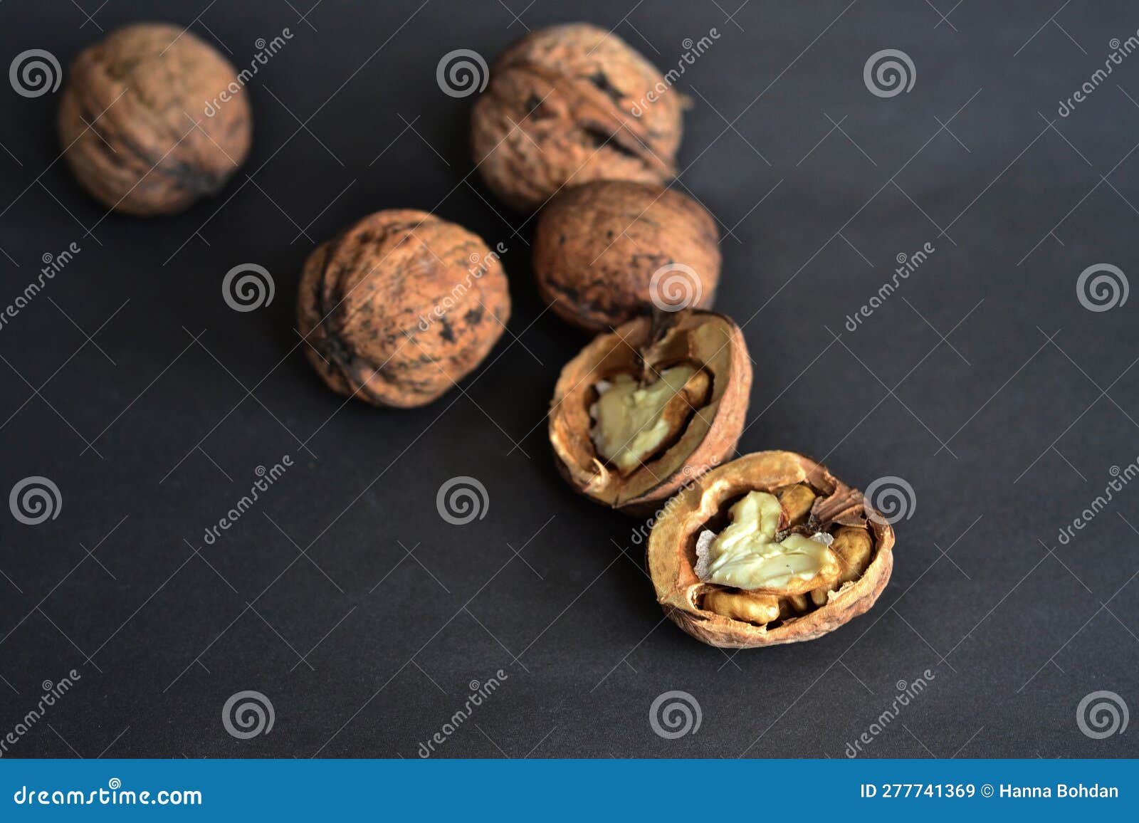 Walnuts Lying on a Black Background and One Split in Half Stock Image ...