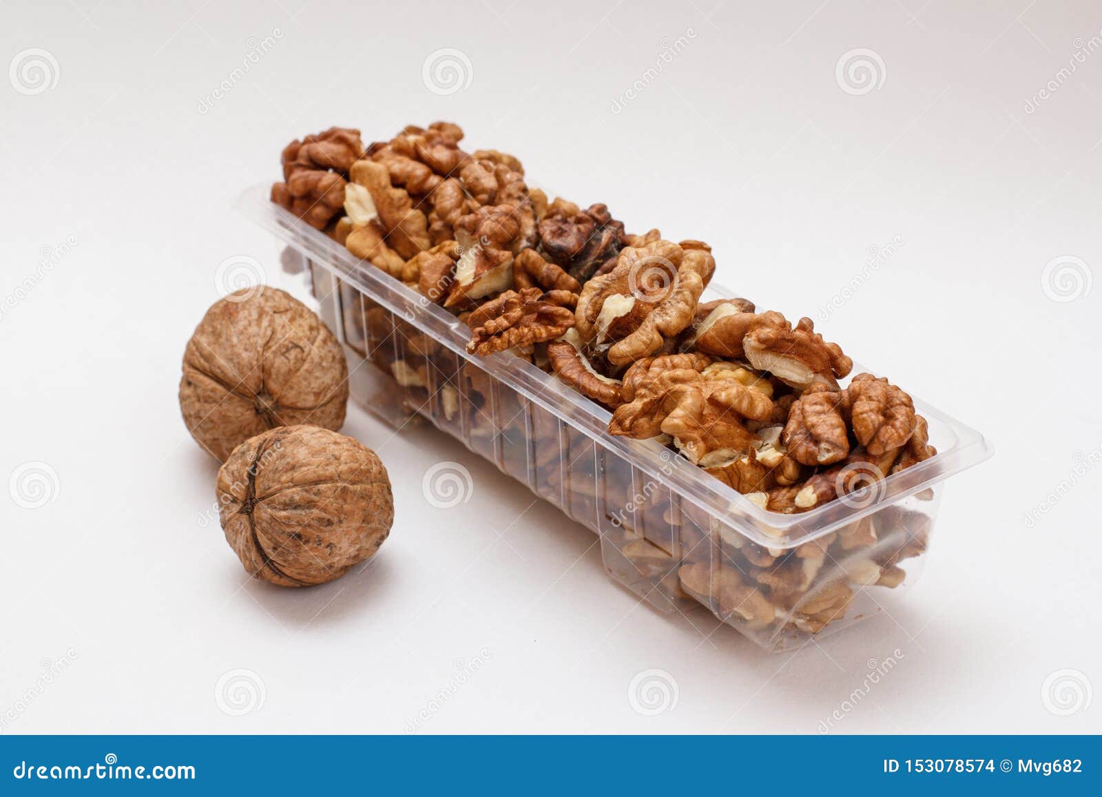 Walnuts in a Plastic Container on the White Background Stock Photo ...