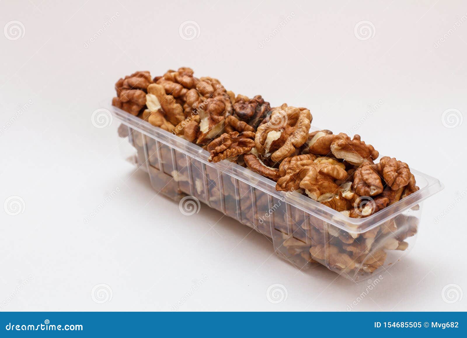 Walnuts in a Plastic Container on the White Background Stock Image ...