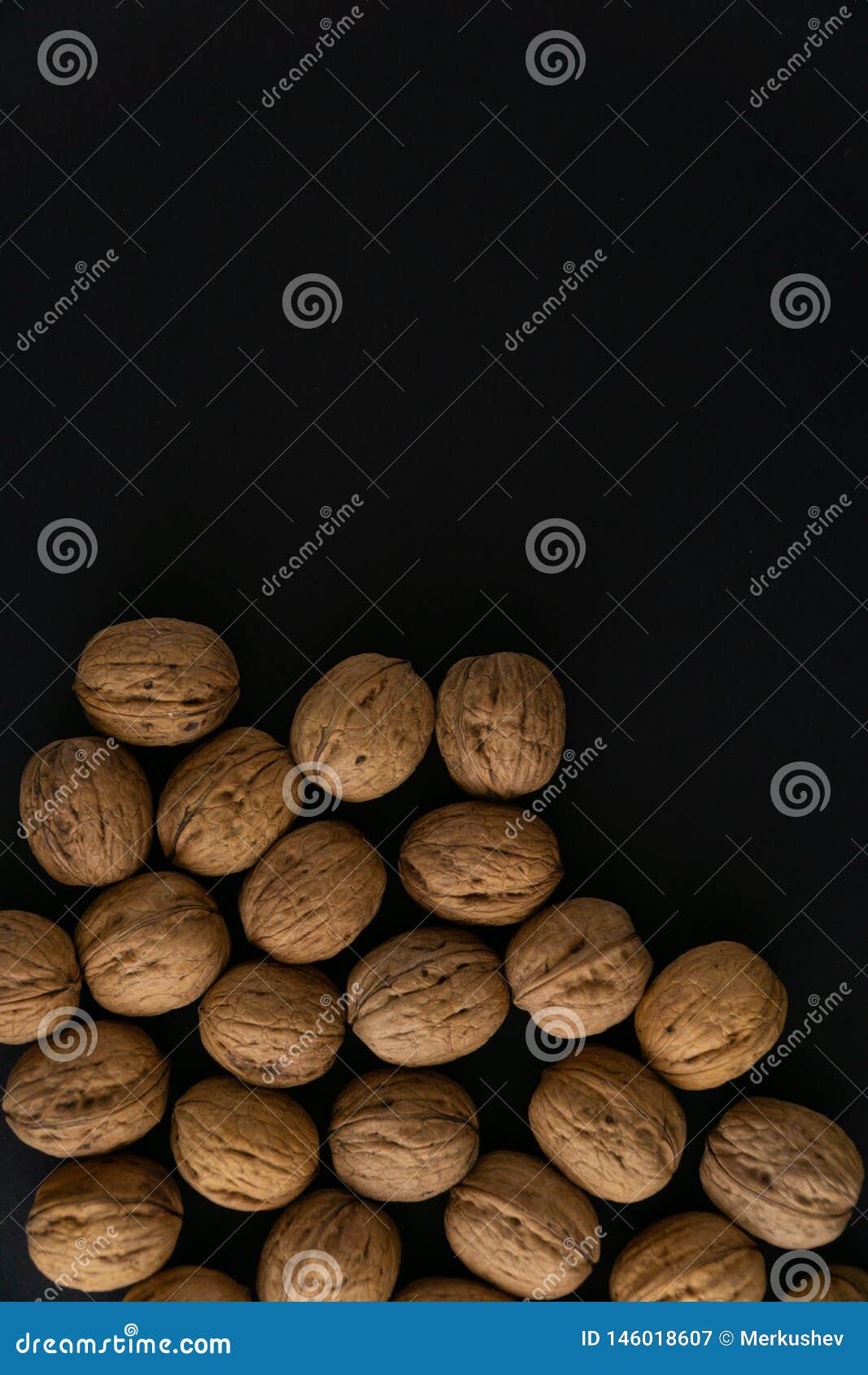 Walnuts in the Shell on Black Surface, Top View. Background of Round ...