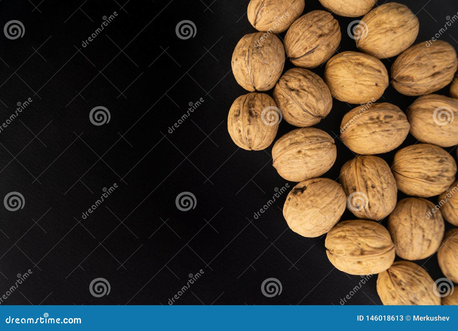 Walnuts in Shell on Black Surface, Top View. Background of Round ...