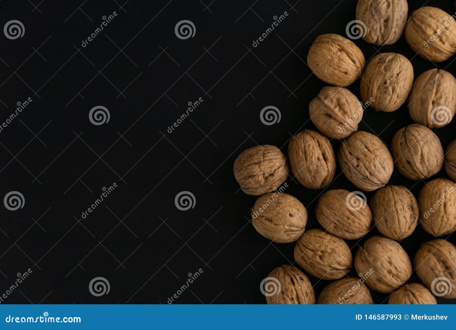 Walnuts in the Shell on Black Surface, Top View. Background of Round ...
