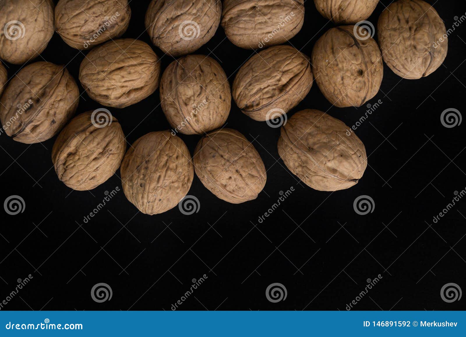 Walnuts in the Shell on Black Surface, Top View. Background of Round ...