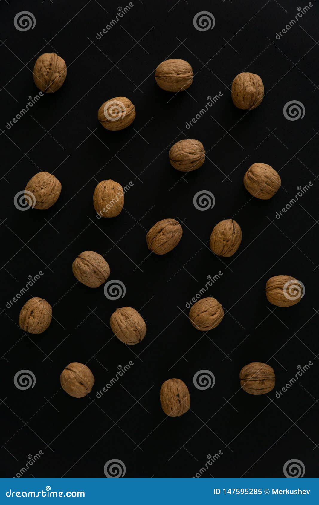 Walnuts in the Shell on Black Surface, Top View. Background of Round ...
