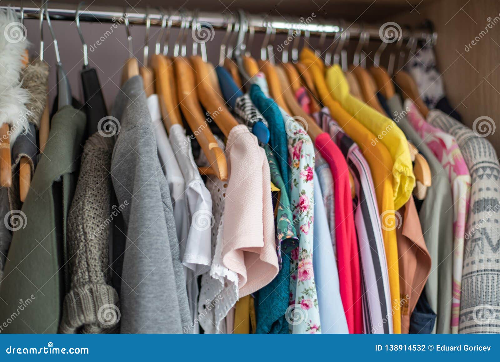 Wardrobe Closet Full of Colorfull Clothes in Dressing-room. Stock Photo ...