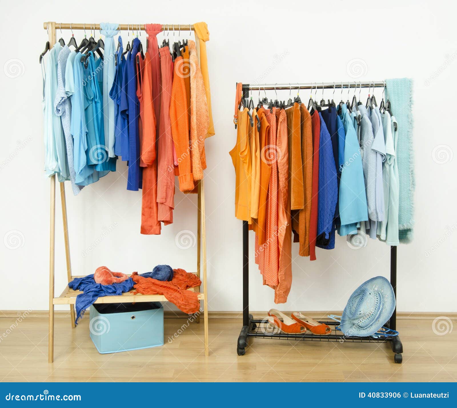 Wardrobe with Complementary Colors Orange and Blue Clothes on Hangers ...