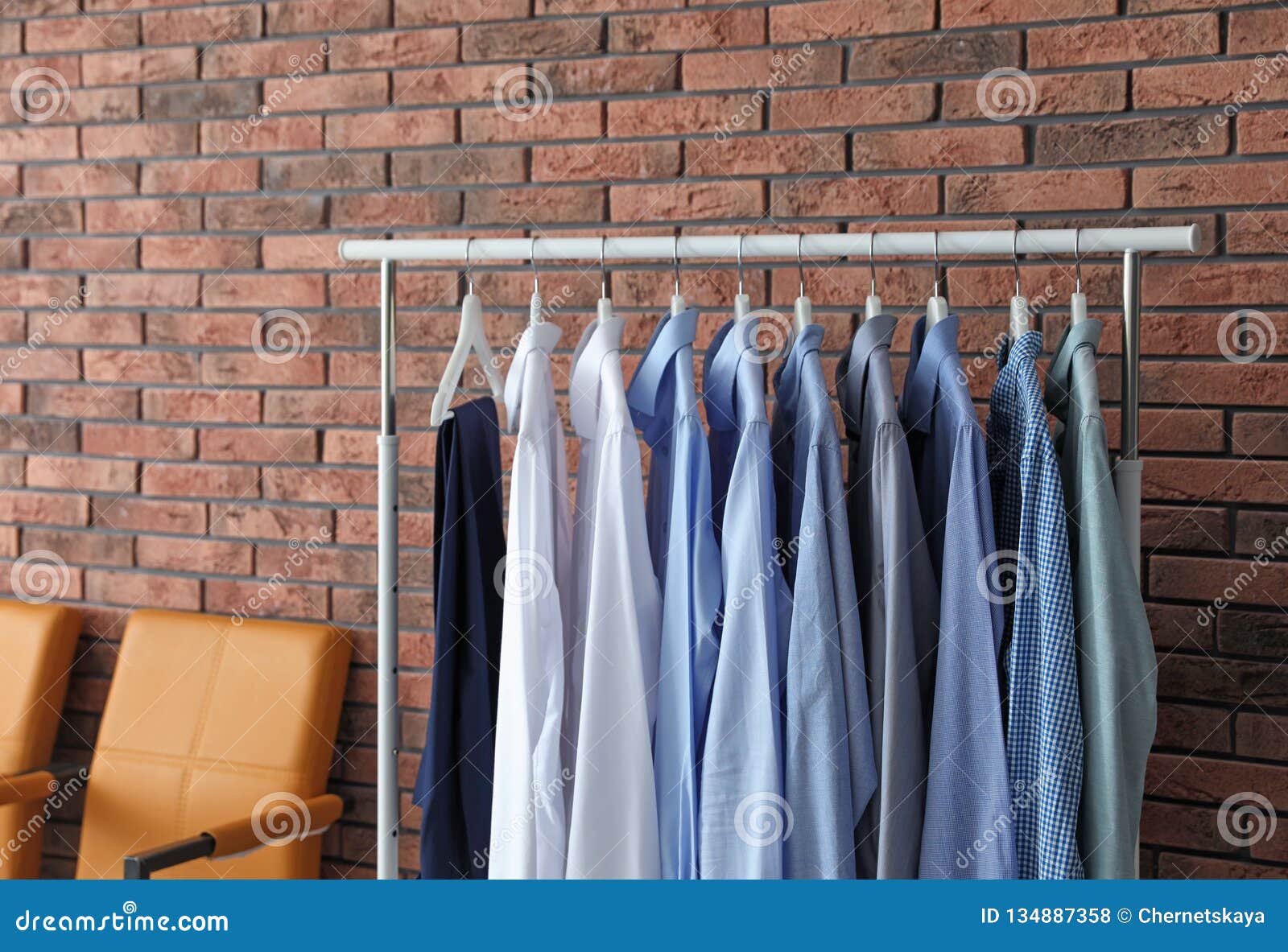 Wardrobe Rack with Men`s Clothes and Chairs Stock Photo - Image of ...