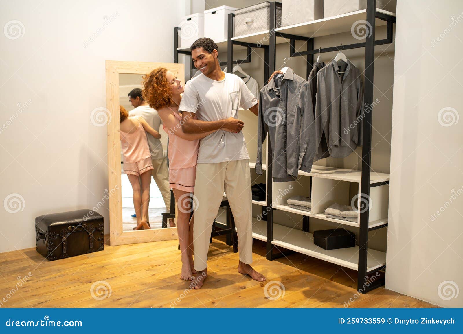 Young Happy Couple in the Wardrobe Choosing Clothes Stock Image - Image ...