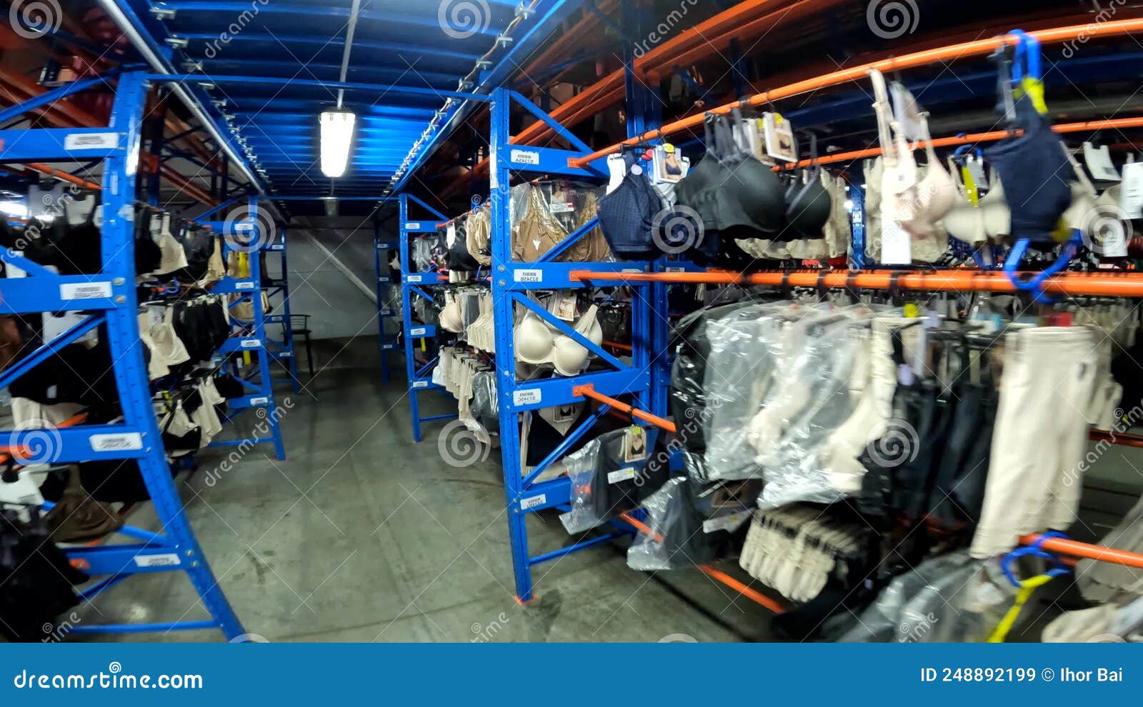 Warehouse with Clothes.the Clothes are Hung in Rows in the Warehouse ...