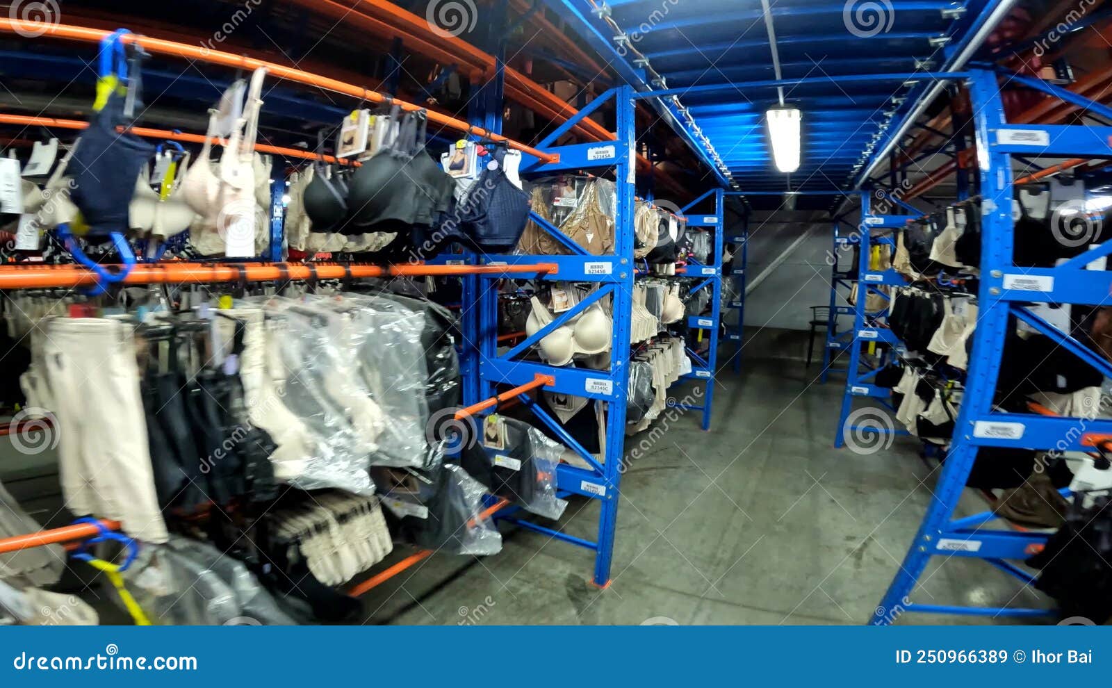 The Clothes are Hung in Rows in the Warehouse. Warehouse with Clothes ...