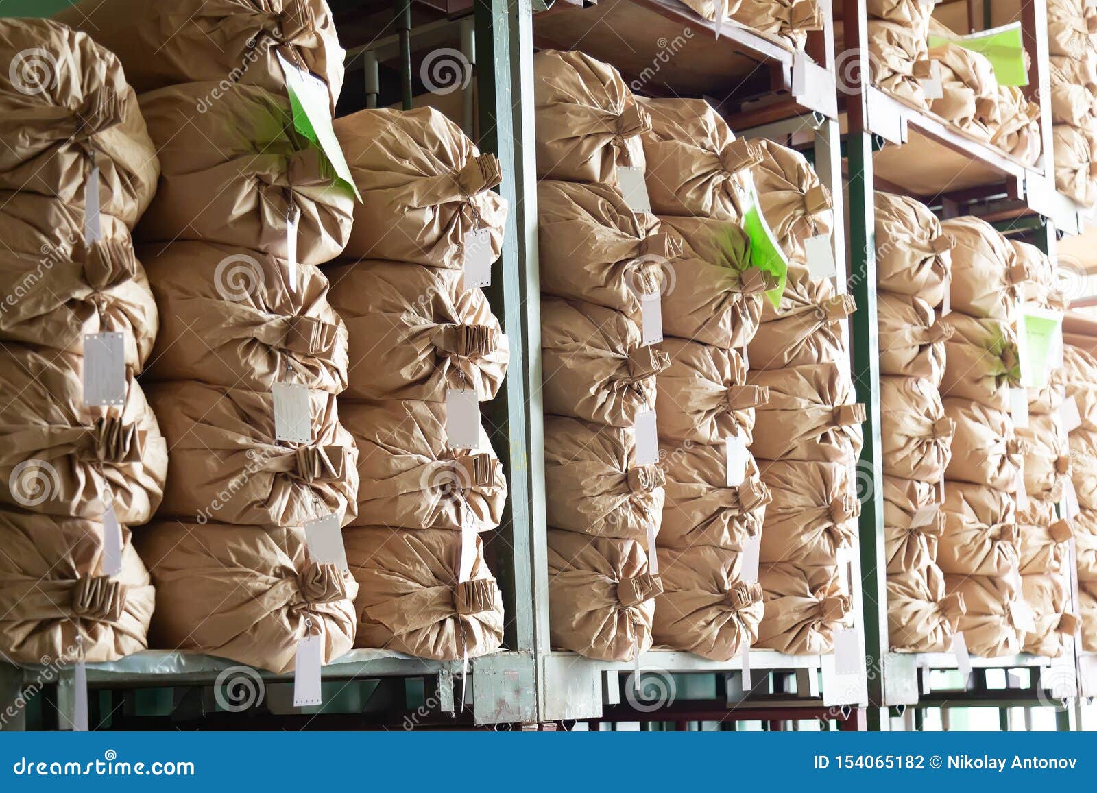 Warehouse Concept. Stacked Paper Sacks in a Warehouse Stock Photo ...