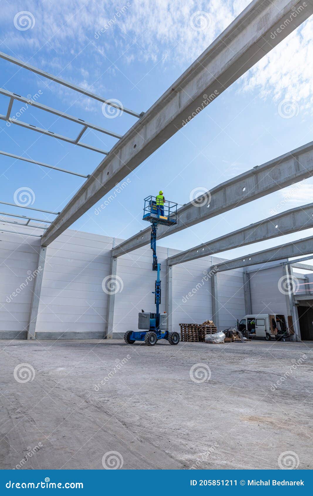 Warehouse Construction. Worker on Mobile Elavating Work Platform Stock ...
