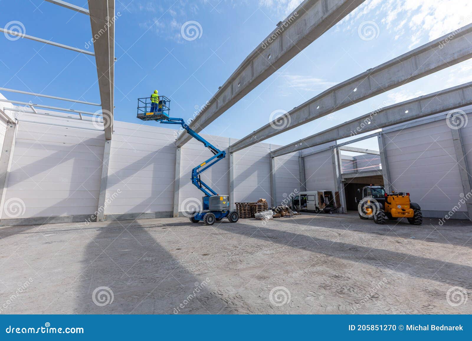 Warehouse Construction. Worker on Mobile Elavating Work Platform Stock ...