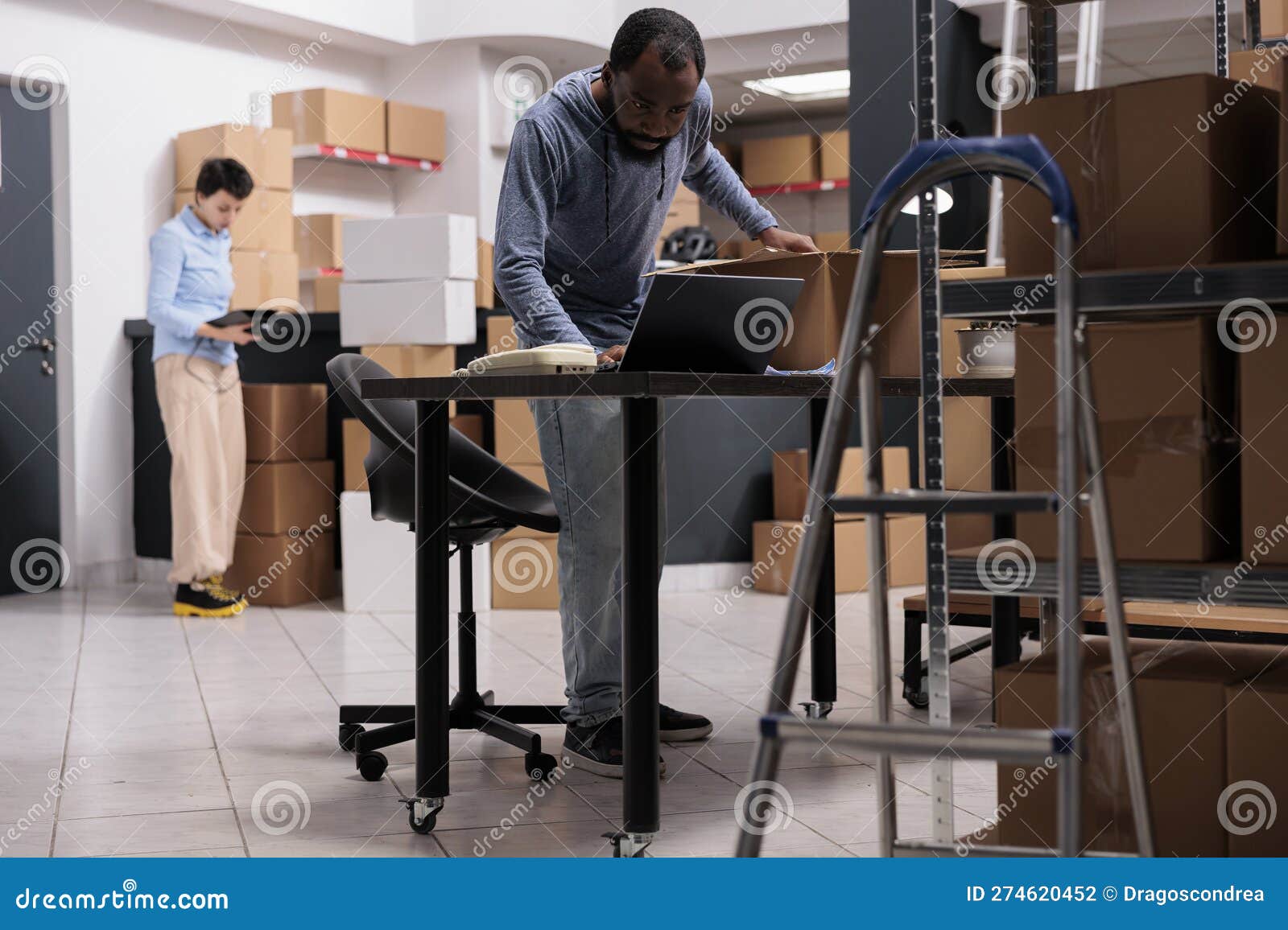 Warehouse Employee Analyzing Transportation Logistics on Laptop ...