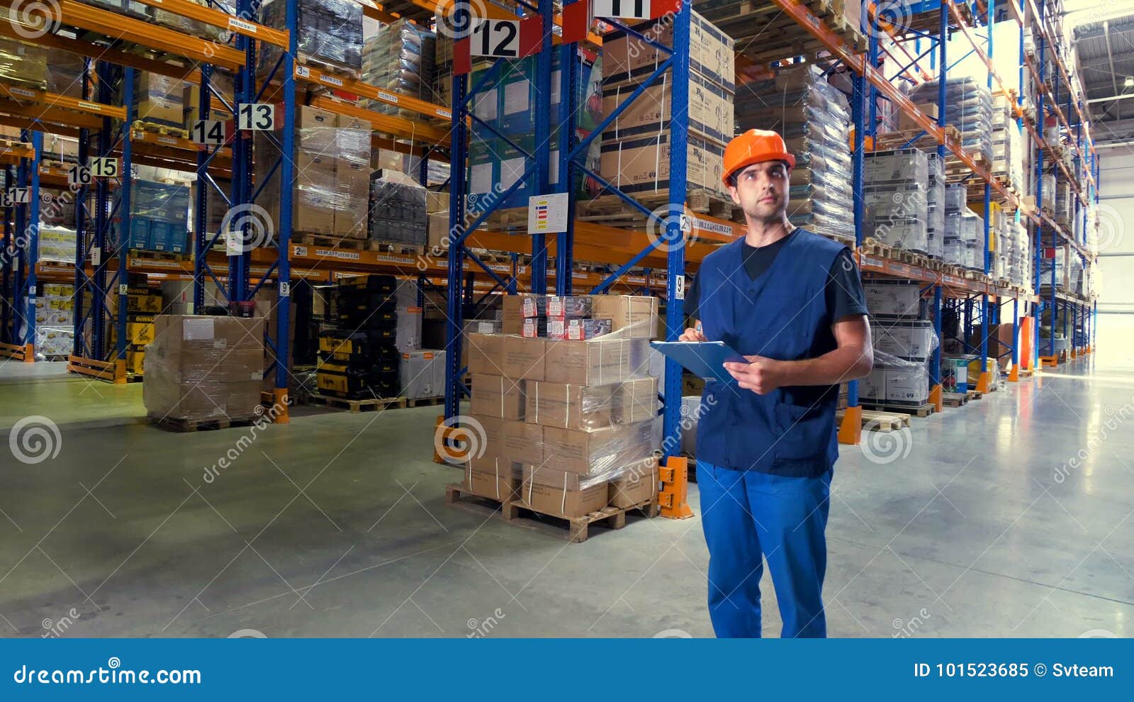 A Warehouse Employee Looks Around Different Aisles. Stock Video - Video ...