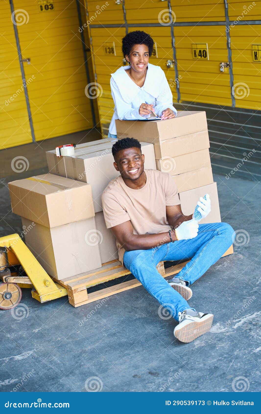Warehouse Employees, a Female Manager and Male Loader, at Workplace ...