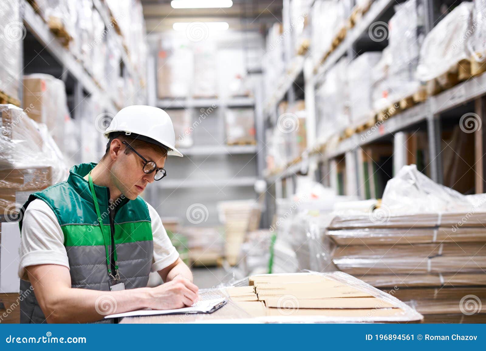 Warehouse Inventory Management. Warehouse Worker is Writing, Keeping ...
