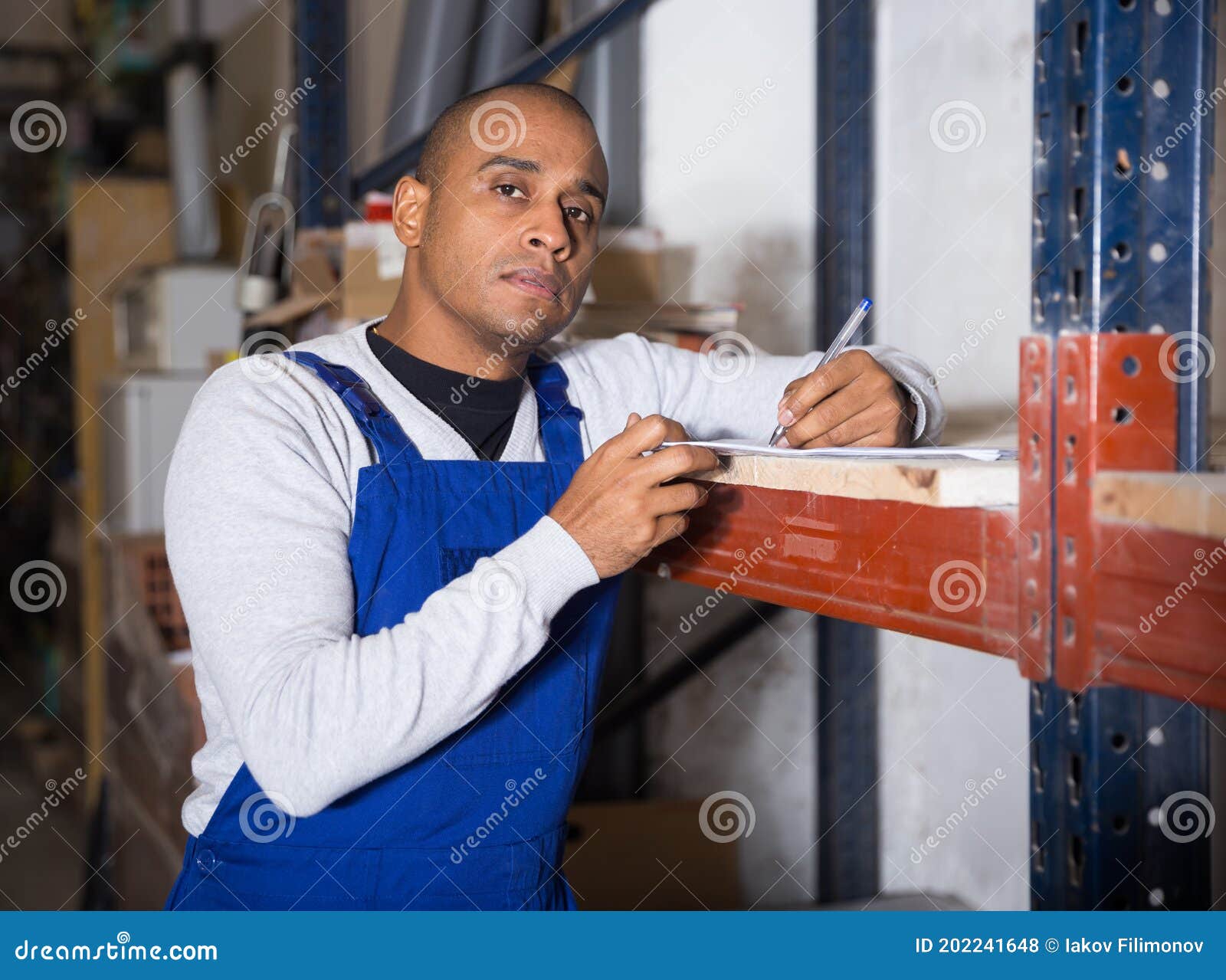 Warehouse Manager Calculates the Quantity of Goods and Writes it Down ...