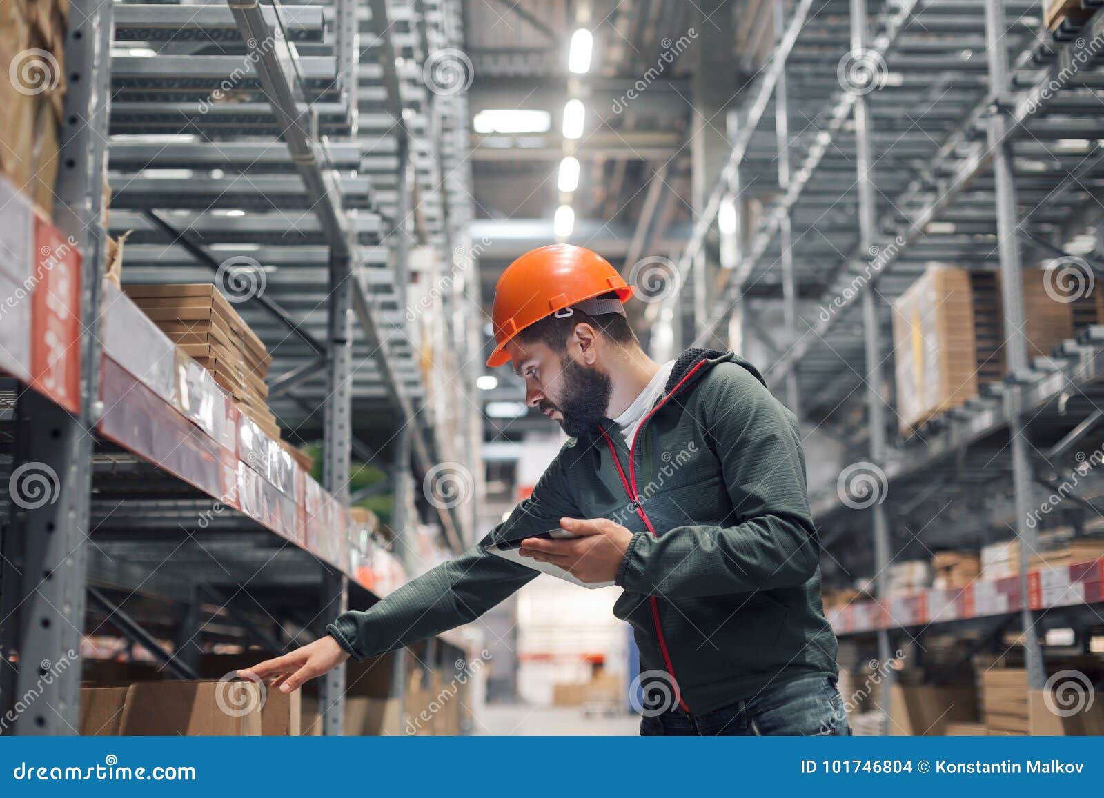 Warehouse Manager Checking His Inventory in a Large Warehouse Stock ...