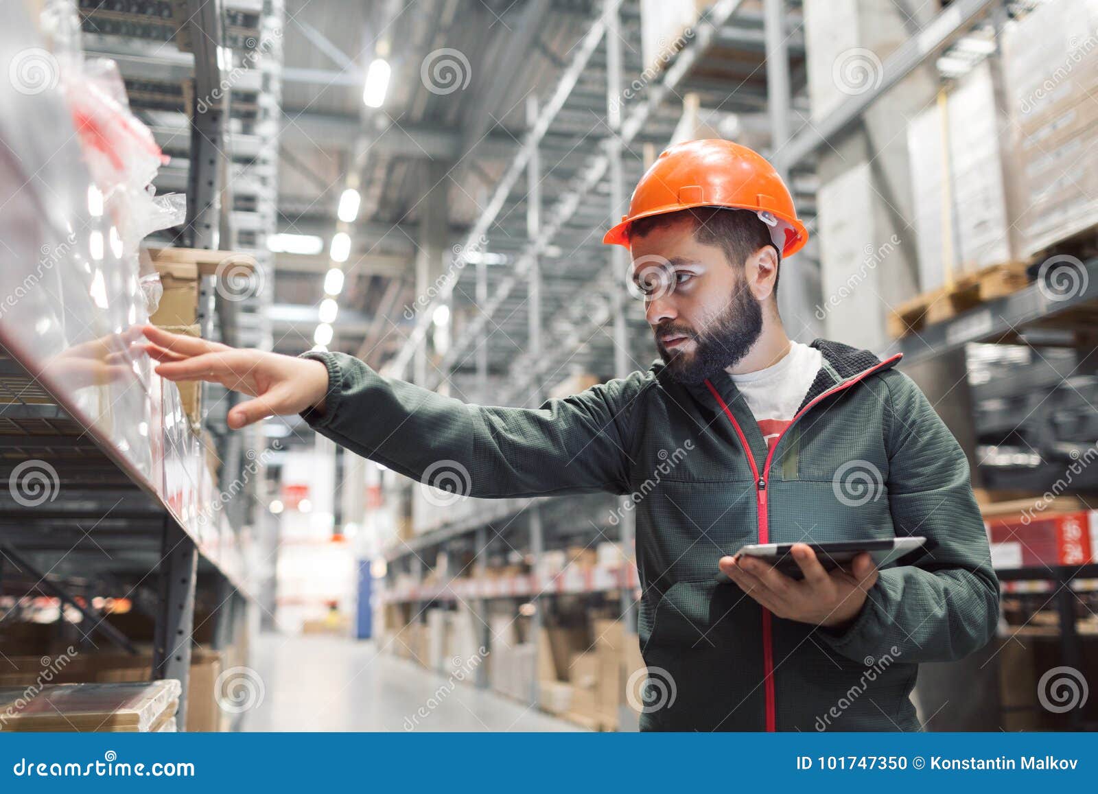 Warehouse Manager Checking His Inventory in a Large Warehouse Stock ...
