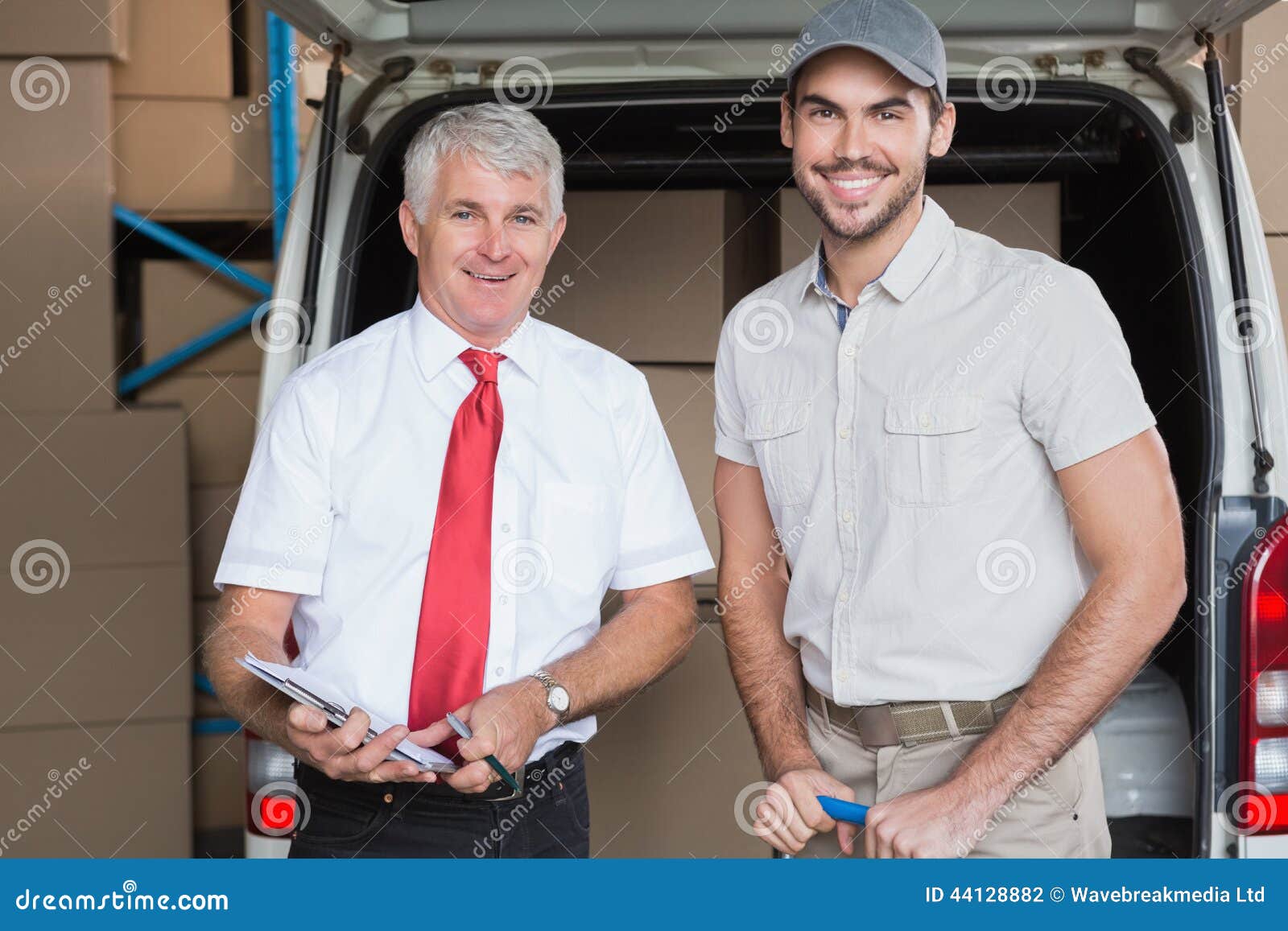 Warehouse Manager and Delivery Driver Smiling at Camera Stock Photo ...
