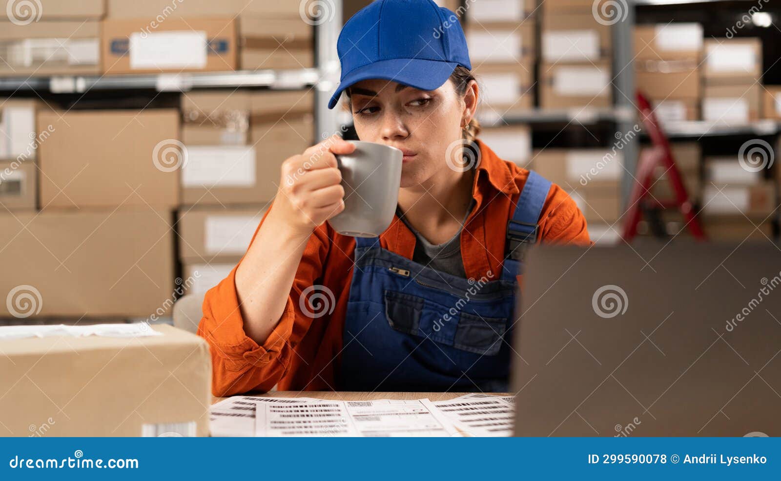 Warehouse Manager Drinking Tea or Coffee Working in Storeroom with Rows ...