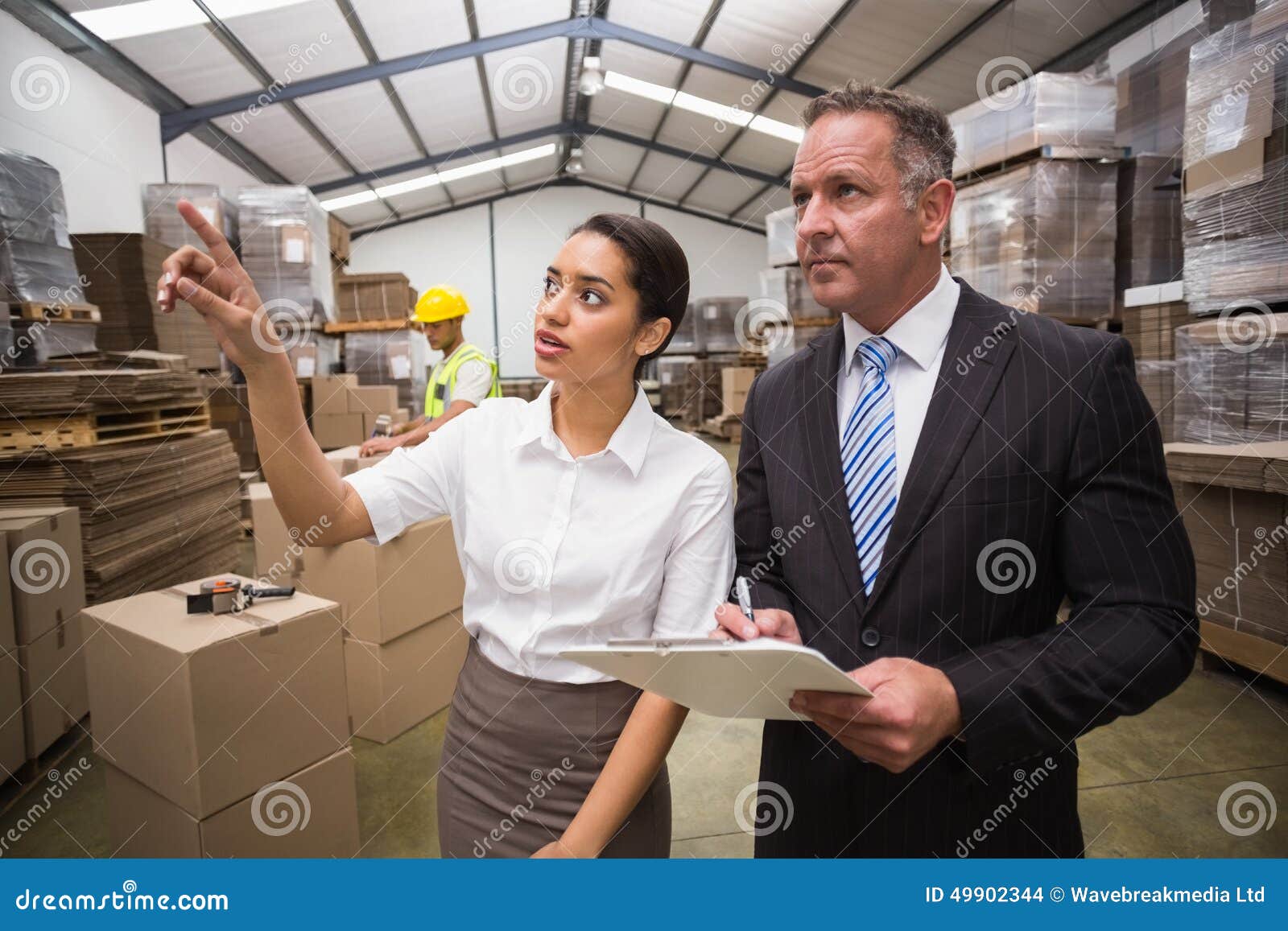 Warehouse Manager Showing Something To Her Boss Stock Photo - Image of ...