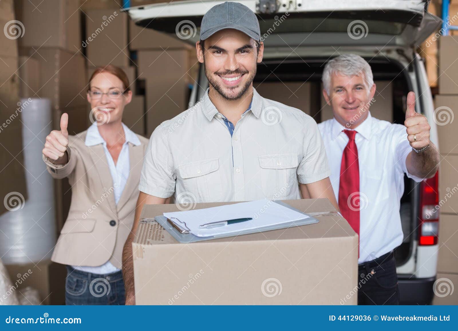 Warehouse Managers and Delivery Driver Smiling at Camera Stock Photo ...