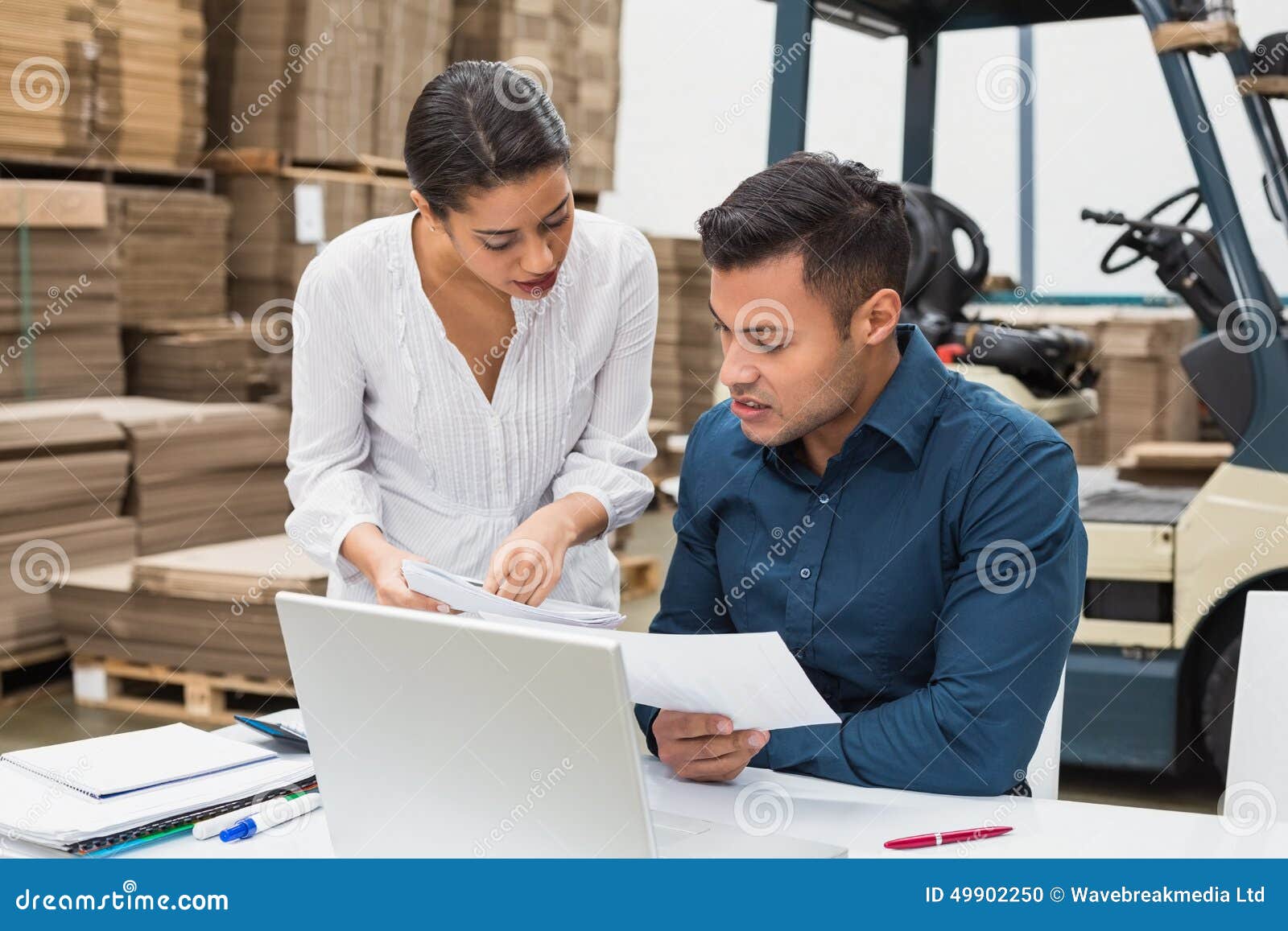 Warehouse Managers Working with Laptop at Desk Stock Photo - Image of ...