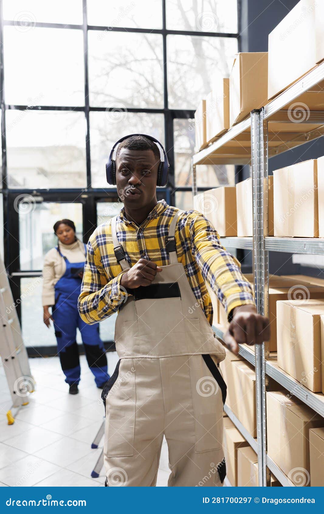 Warehouse Package Handler Dancing at Work Looking at Camera Stock Image ...