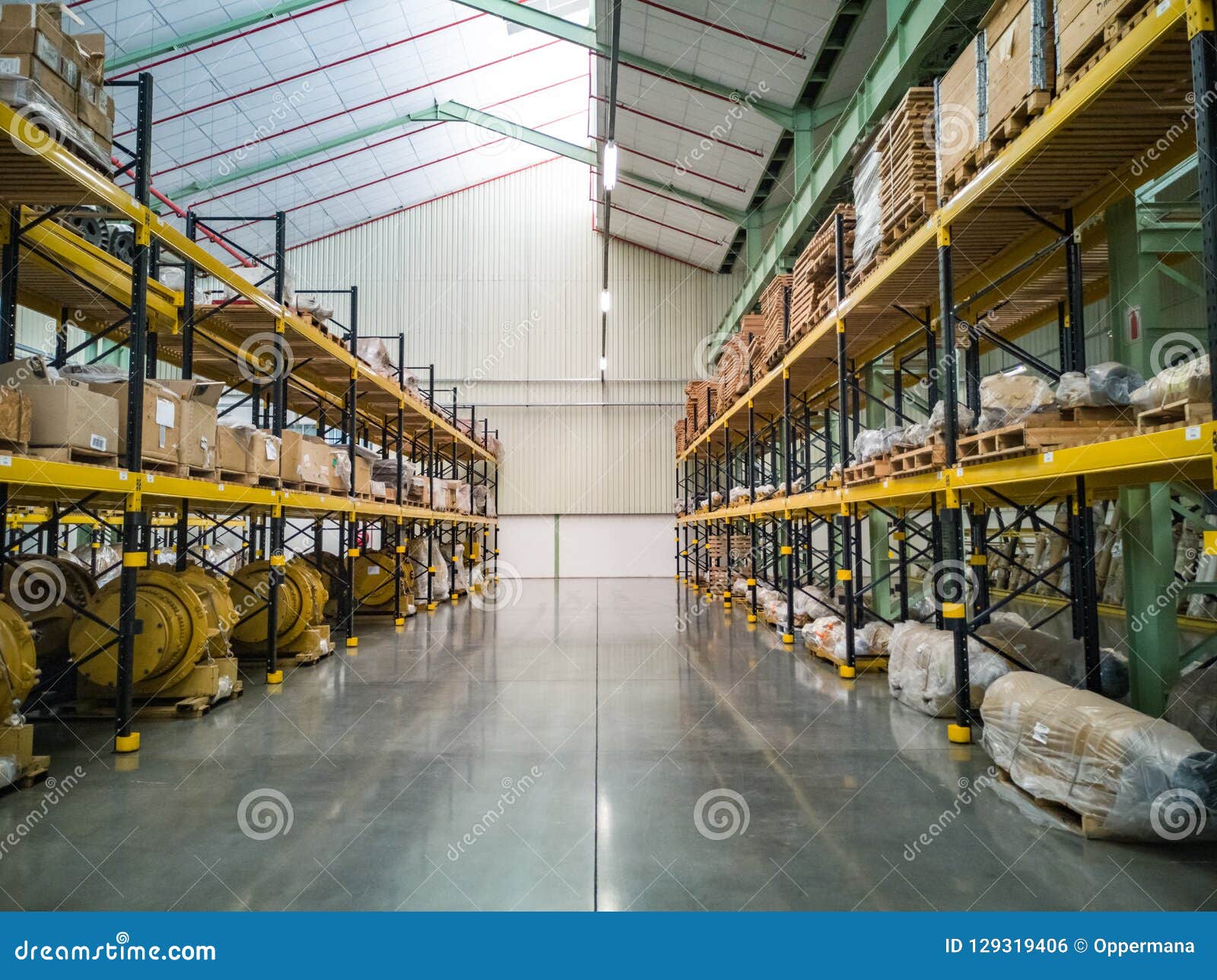 Warehouse with Stacked Yellow Shelving and Clean Floor Stock Photo ...