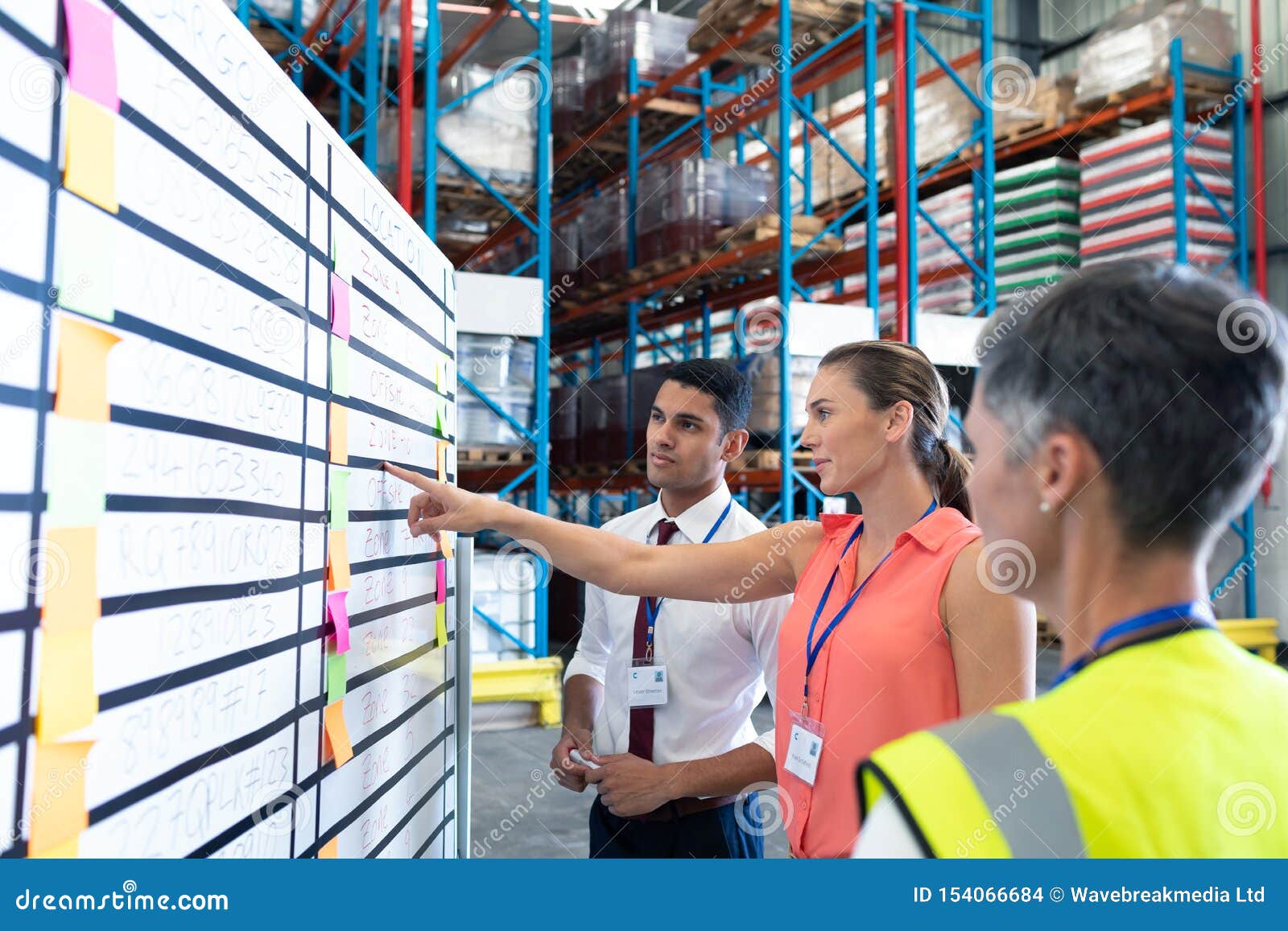 Warehouse Staffs Discussing Over Whiteboard in Warehouse Stock Photo ...