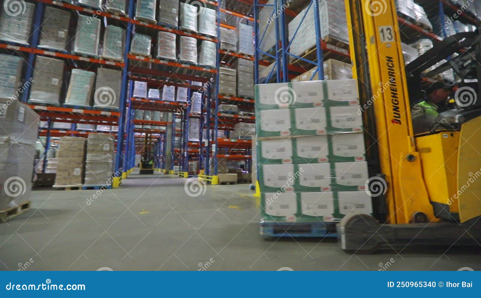 Warehouse Work. Modern Loaders in a Large Warehouse. Workflow in a ...
